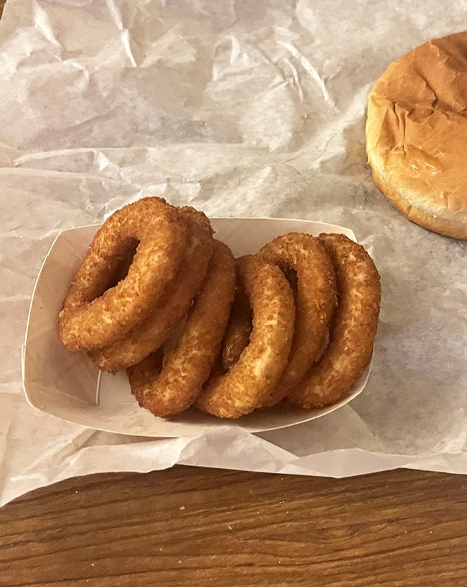 Onion rings stacked like golden halos—crispy, substantial, and without a hint of pretense. Fast food chains, take notes.