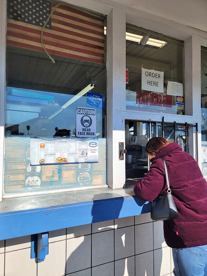 The ordering window—where dreams come true and diet plans go to die. Worth every calorie and every minute in line.