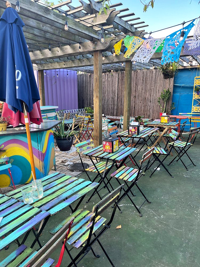 Rainbow tables under Florida skies! This technicolor outdoor seating area feels like dining inside a box of crayons—in the best possible way.