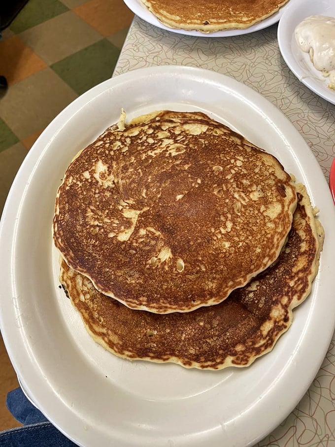 Pancakes so perfectly golden they belong in Fort Knox. The plate-sized discs aren't just breakfast—they're edible comfort blankets for your soul.