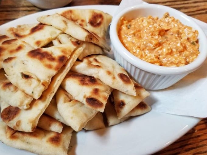 Warm pita triangles with creamy dip – the appetizer equivalent of a friendly handshake that says, "Trust me, the main course is going to blow your mind."