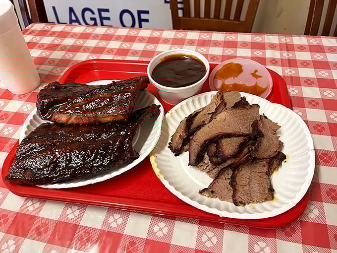 A red-checkered tablecloth sets the perfect stage for this meat duet—ribs singing bass notes while brisket handles the tenor.