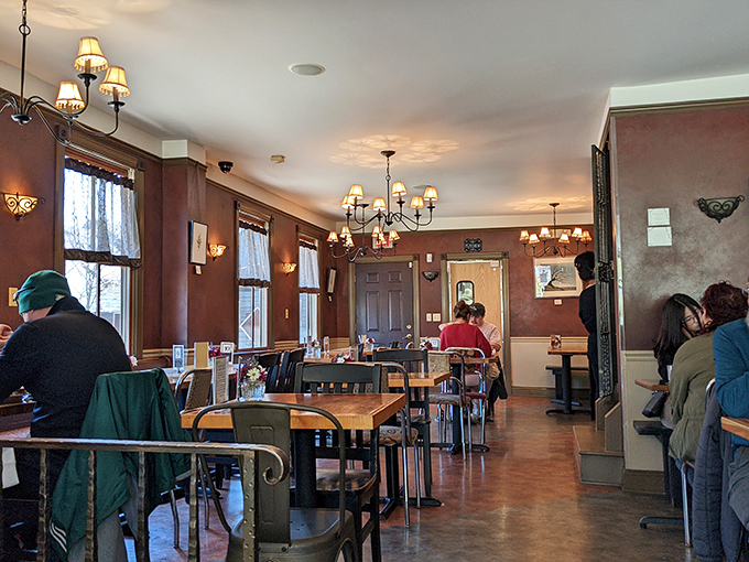 Warm lighting, mismatched chairs, and the gentle hum of satisfied diners—this dining room feels like Sunday morning in physical form.