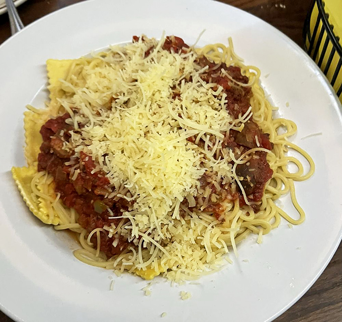 Classic spaghetti topped with generous cheese, proving this steakhouse knows comfort food extends beyond beef.