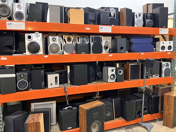 The speaker wall – audio equipment spanning decades, from "this powered my college dorm parties" to "I have no idea what this connects to anymore."
