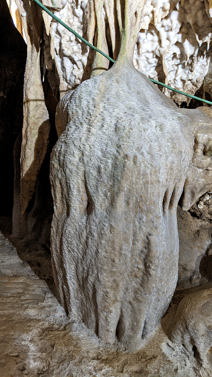 This stalagmite looks like it's auditioning for a role in a fantasy film—the wise old stone sage waiting to dispense advice.