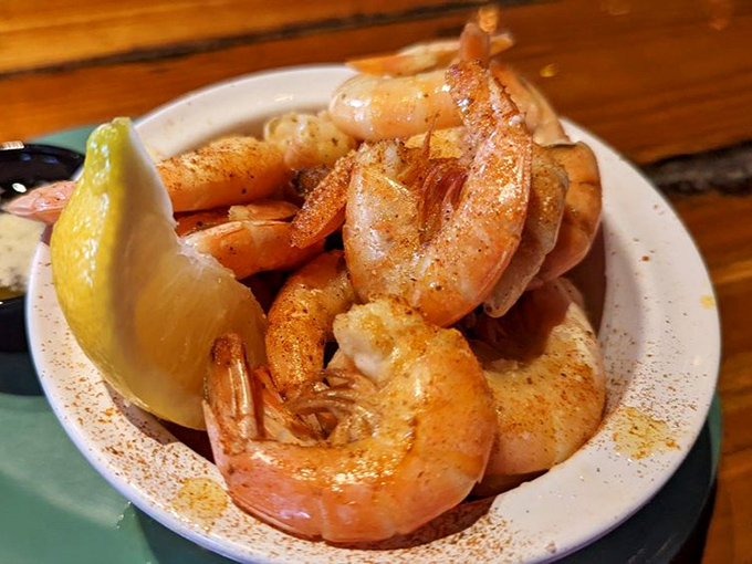 These pink beauties aren't just steamed shrimp—they're the ocean's candy, dusted with spices and waiting for their lemon bath.