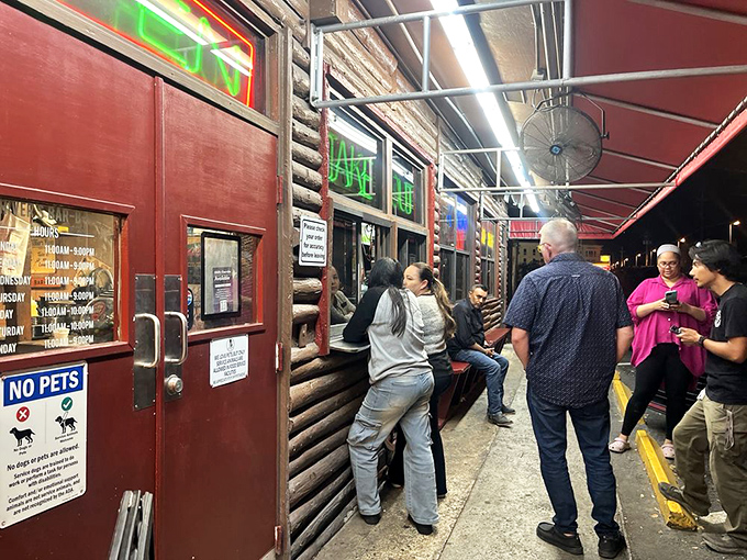 The takeout window where patience is rewarded with packages of joy – proof that good things come to those who wait.