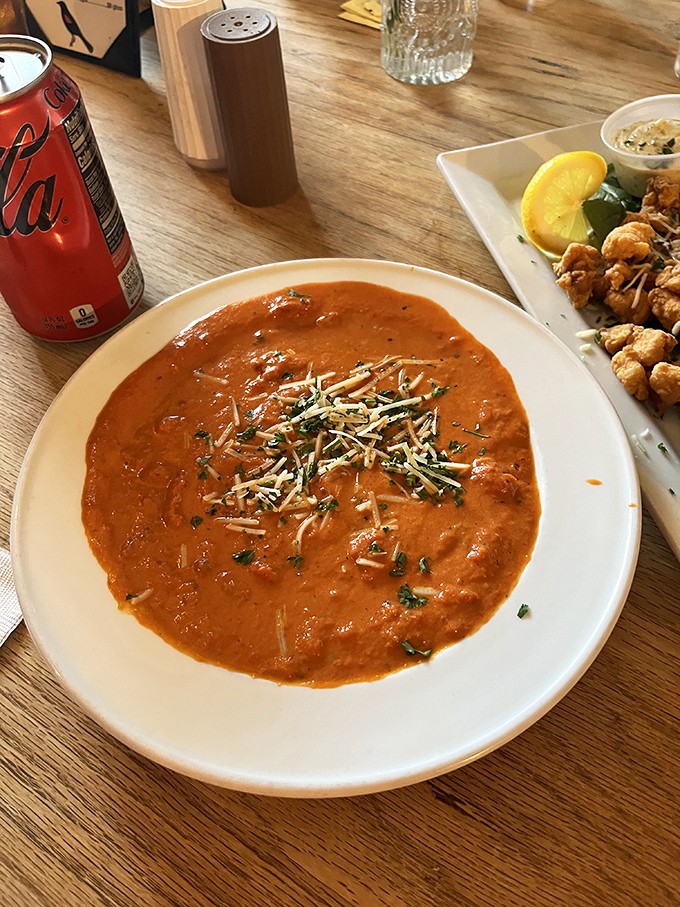 Tomato soup that glows like a Florida sunset, topped with cheese that melts into the warm depths below.