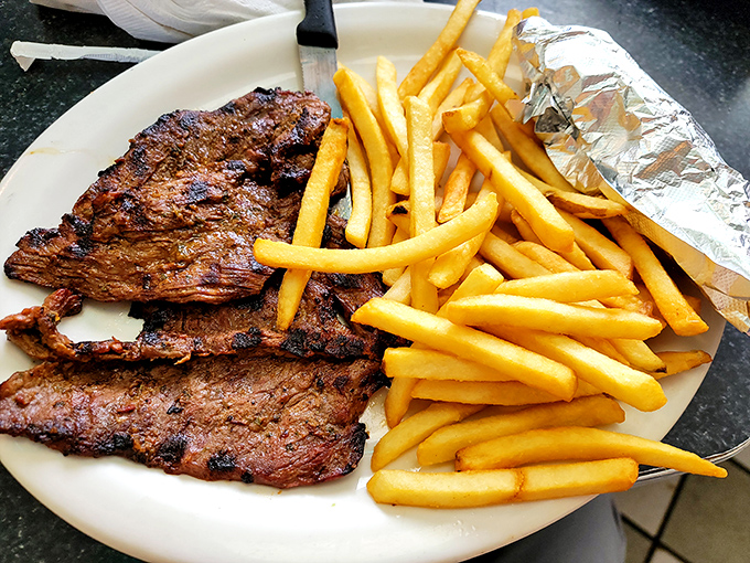 Perfectly grilled asado with golden fries—sometimes the simplest dishes reveal a kitchen's true talent.