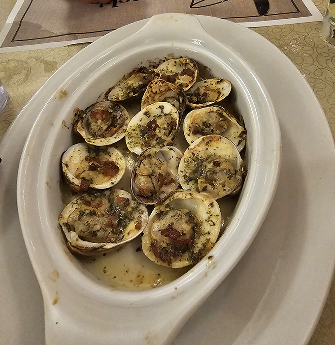 Baked clams swimming in buttery, garlicky goodness – the kind of appetizer that makes you contemplate ordering a second round.