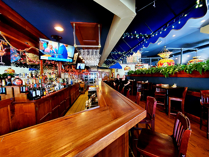 The gleaming wooden bar invites both serious conversations and lighthearted banter – the beating heart of Sycamore Grille's community spirit.