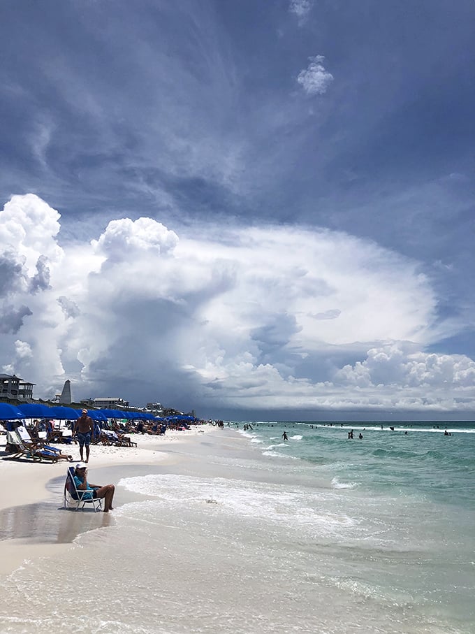 Storm clouds create nature's drama over Seaside's perfect beach, where even rainy days become spectacular photo opportunities worth framing.