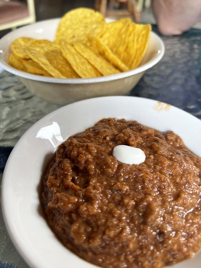 This isn't just bean dip—it's a warm, spiced revelation with homemade chips. The kind of starter that makes you reconsider your entire relationship with beans.