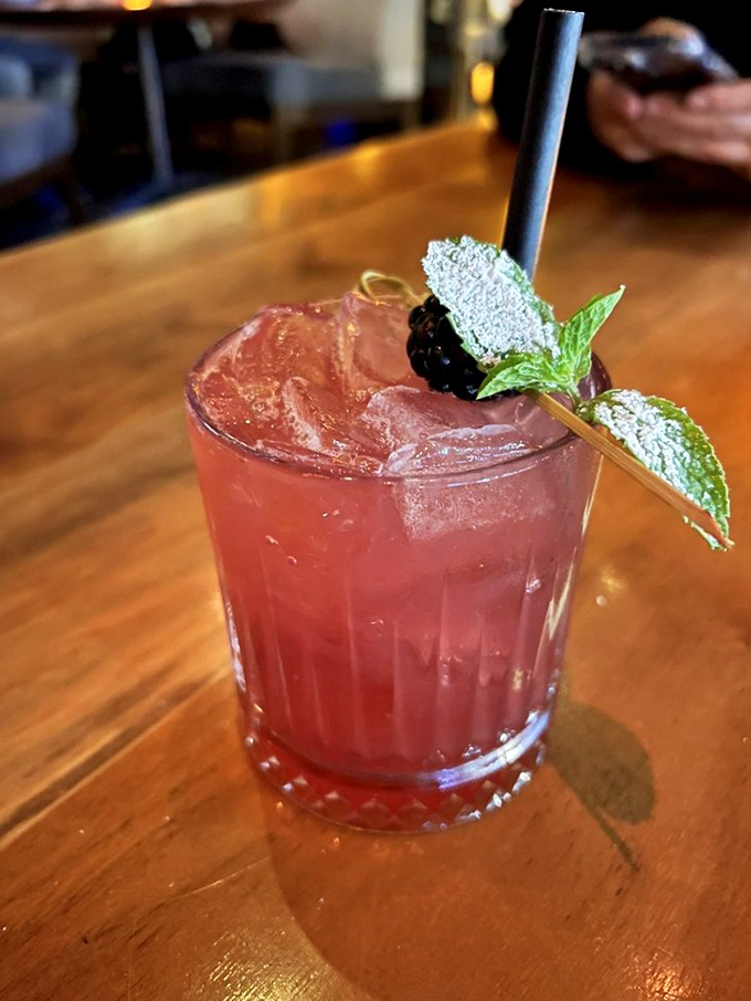 This isn't just a cocktail—it's a refreshing escape in a glass, garnished with fresh berries and mint for that perfect California twist.