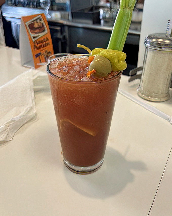 This isn't just a Bloody Mary—it's a garden in a glass, complete with a celery stalk standing tall like a proud parent.
