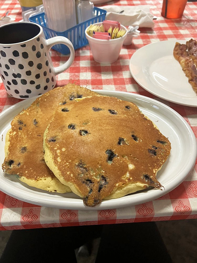 Blueberry pancakes that strike the perfect balance between fluffy and substantial—each purple burst a tiny reminder that nature's candy belongs at breakfast.