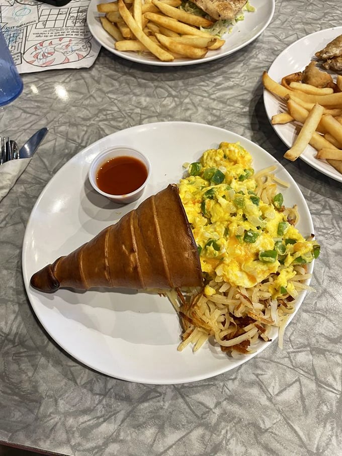 The breakfast "conewich" – proof that innovation isn't dead in diners, with eggs and hash browns nestled in a croissant cone of genius.