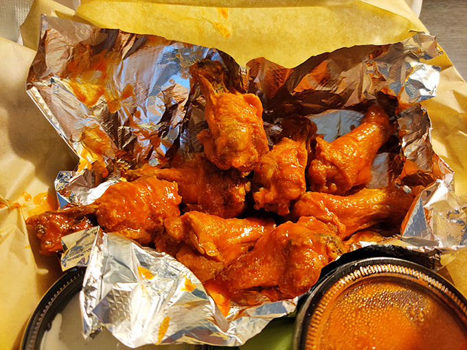 Buffalo wings that don't mess around—they come dressed for the occasion in sauce that's both a warning and a promise.