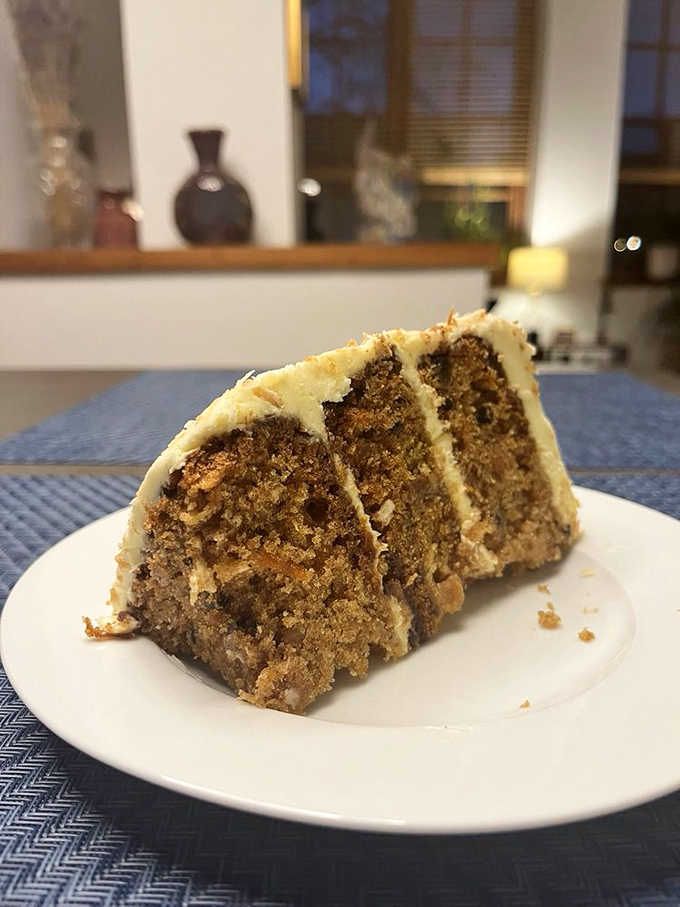 This isn't just carrot cake—it's three layers of moist, spiced perfection that makes you wonder why anyone bothers with other desserts.