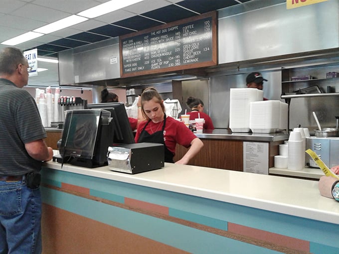 The friendly face behind the counter where orders become edible memories and strangers become temporary family.