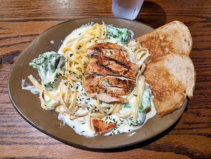 Pasta that doesn't play second fiddle to the steaks—creamy fettuccine, perfectly grilled chicken, and broccoli for those who need to pretend they're eating healthy.