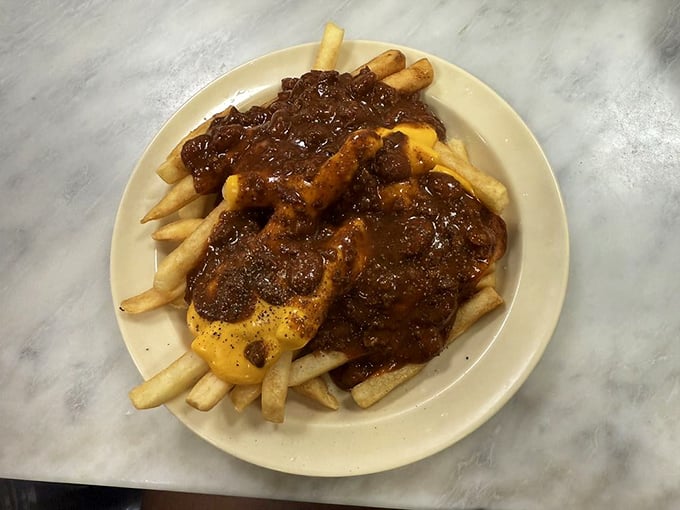 Fries baptized in chili and cheese—a holy trinity of comfort that makes you forget about things like "moderation" and "cholesterol."