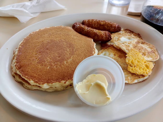 The breakfast plate that launched a thousand productive days – golden pancake flanked by sunny eggs and sausage standing at attention.