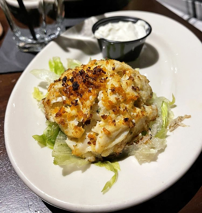 The crab cake that respects its main ingredient. Minimal filler, maximum flavor, and a golden crust that crackles with each forkful.