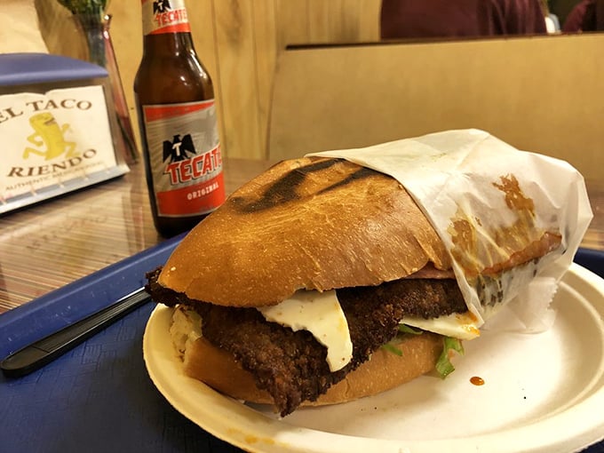 The Cubano torta—where bread meets meat in a sandwich so substantial it deserves its own zip code. Tecate standing by for backup.