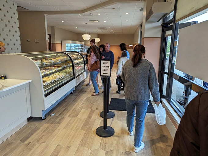 The universal language of anticipation—customers patiently waiting for their turn at the display case. Some decisions are worth contemplating with reverence.
