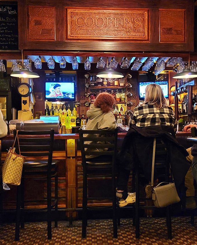 Local diners gather at the bar, creating that authentic neighborhood atmosphere where everyone becomes a regular eventually. 