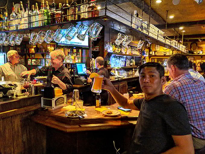 The bar isn't just where drinks are served—it's where strangers become friends and food becomes the universal language everyone suddenly speaks fluently.