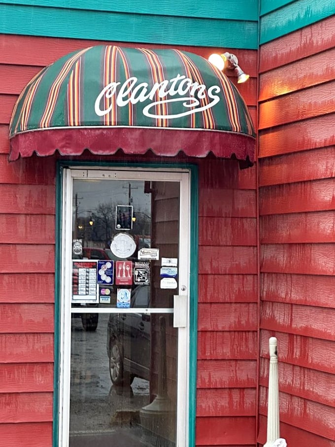 Not just an entrance—a portal to comfort food paradise, where the striped awning promises shelter from both weather and complicated dining trends.