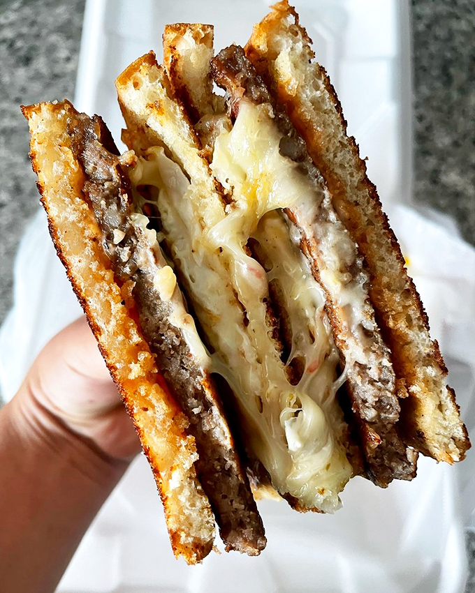 The maple bacon cinnamon roll—where breakfast meets dessert in a union so perfect it should have its own reality show.