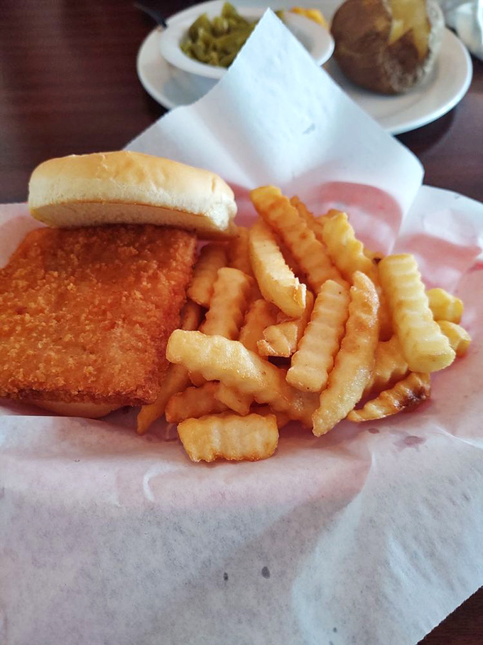 The breaded pork tenderloin sandwich – Indiana's unofficial state food – served with crinkle fries that crunch like autumn leaves.