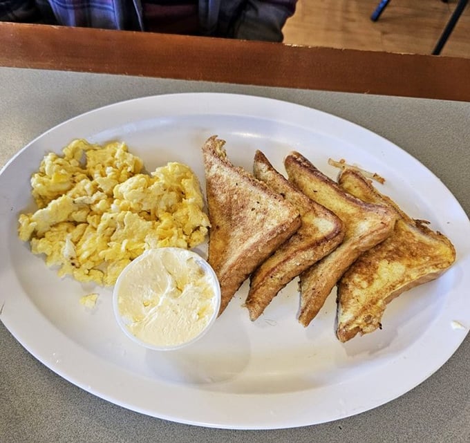 Golden triangles of French toast alongside perfectly scrambled eggs—simple breakfast perfection that needs no fancy garnish or pretentious description.