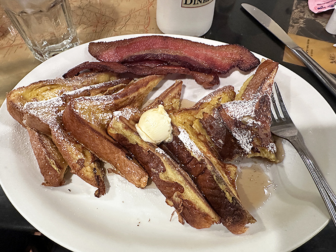 French toast that's achieved breakfast nirvana—crispy edges, custardy centers, and a dusting of powdered sugar that melts into the maple syrup.