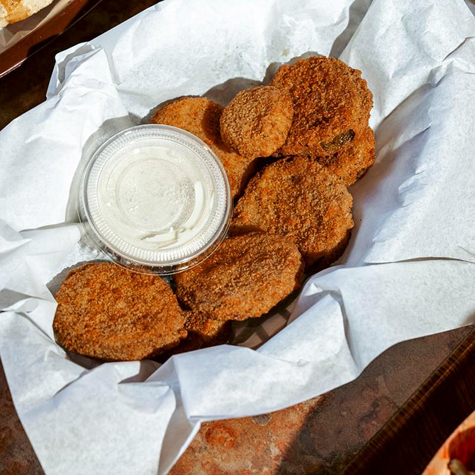 Fried green tomatoes – proof that anything becomes magical when breaded, fried, and served with a side of creamy dipping salvation.