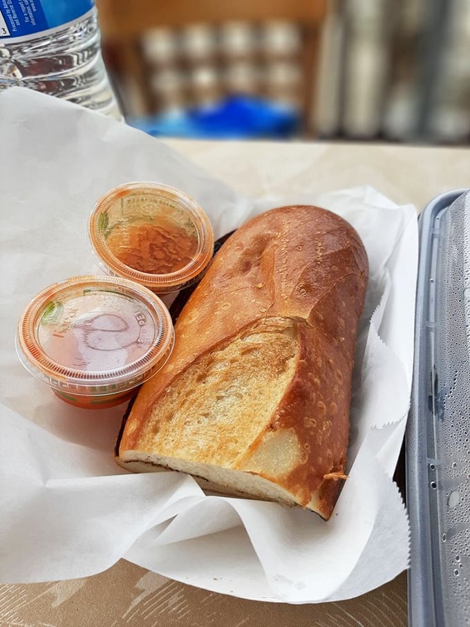 Crusty sourdough bread served with dipping sauces – because sometimes you need a brief intermission between acts of seafood brilliance.