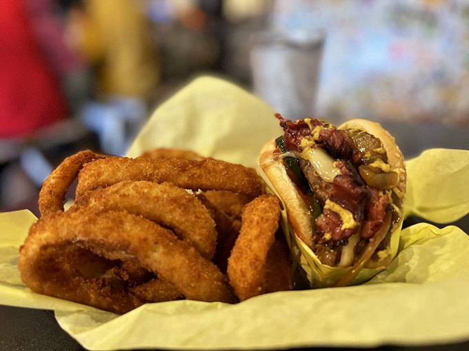 The Guido Burger with onion rings – a masterclass in contrast where the crispy, golden rings provide the perfect counterpoint to the juicy, flavor-packed burger.