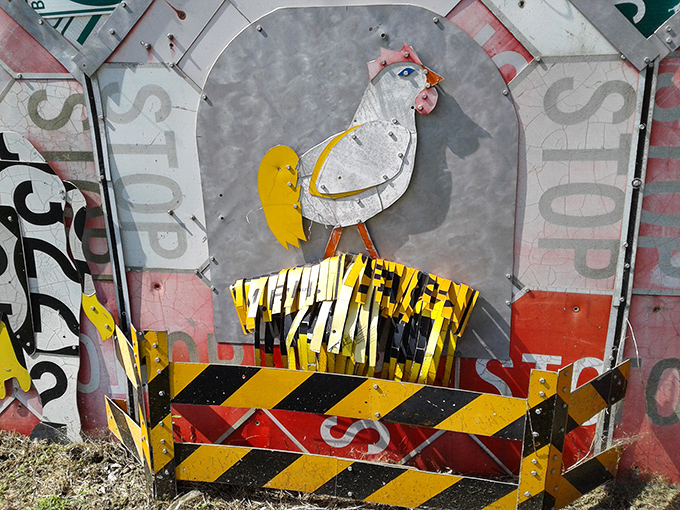 Why did the chicken cross the road? To become immortalized in this whimsical sculpture that turns cautionary signage into a barnyard vignette worth crowing about.