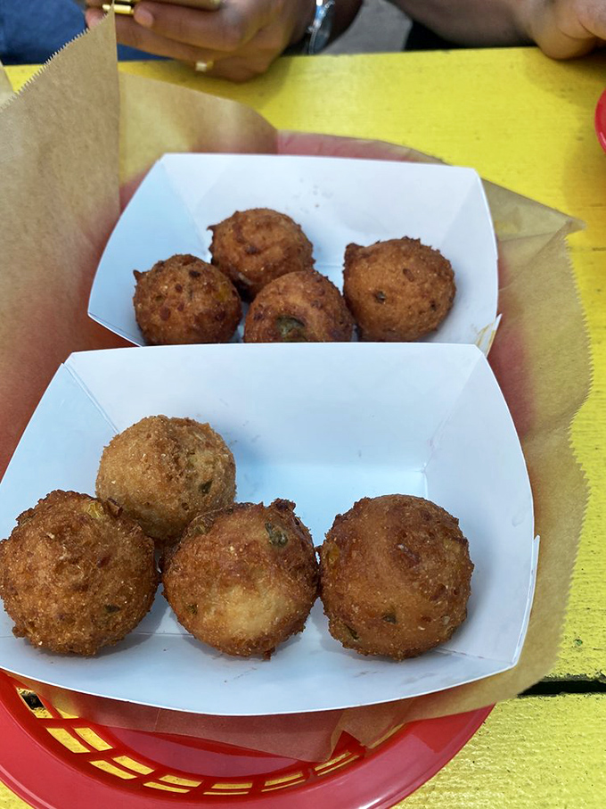 Hush puppies so perfect they should come with a warning: "May cause involuntary sounds of delight." Crispy outside, tender inside—pure Southern gold.