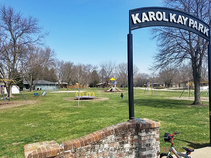 Karol Kay Park's entrance promises simple pleasures – swings, slides, and the timeless joy of watching children discover the magic of outdoor play.