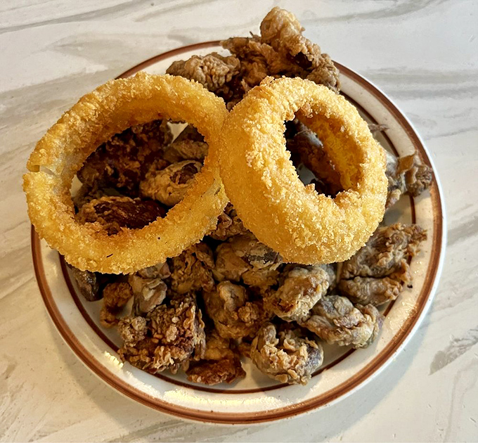 For the culinary adventurer: crispy livers and gizzards with golden onion rings – parts unknown that deserve to be found.