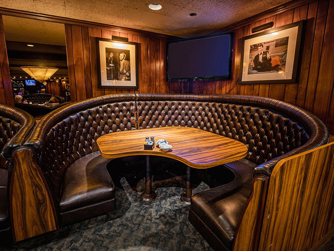 These curved booths aren't just seating—they're cocoons of comfort where time slows down and food tastes better. Wood paneling adds vintage charm.