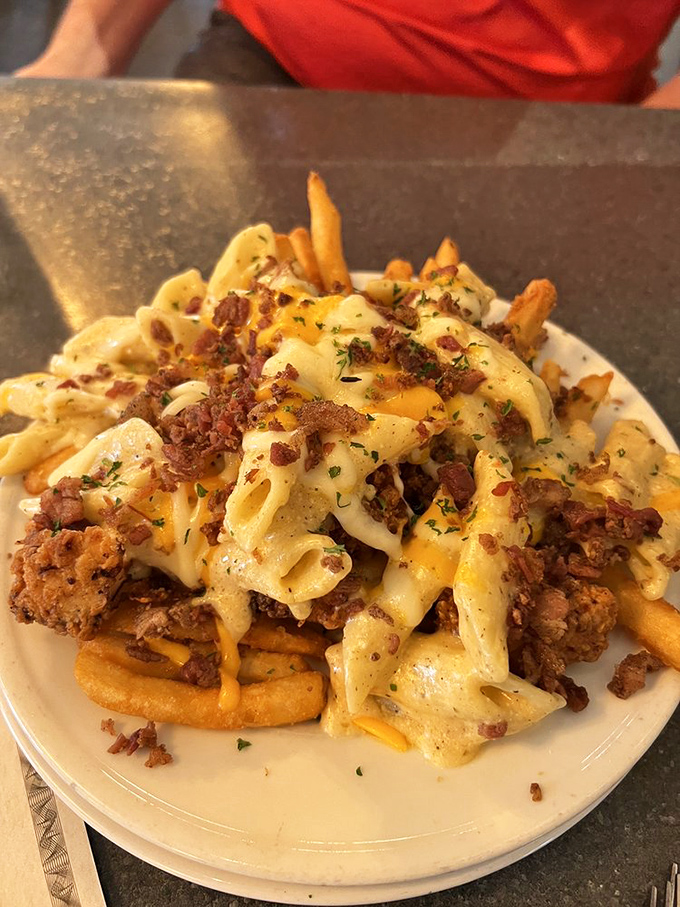 Comfort food engineering at its finest—pasta, cheese, fries and meat coming together in a dish that laughs in the face of diet culture.