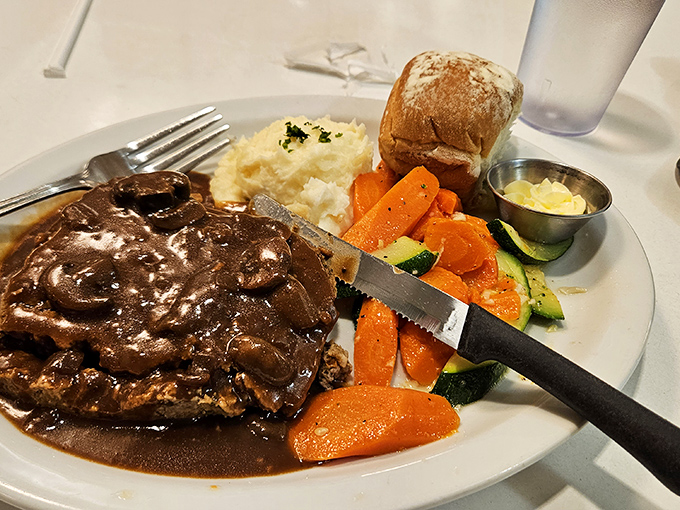 Meatloaf swimming in rich gravy alongside cloud-like mashed potatoes – comfort food that whispers "everything's going to be okay" with every bite.