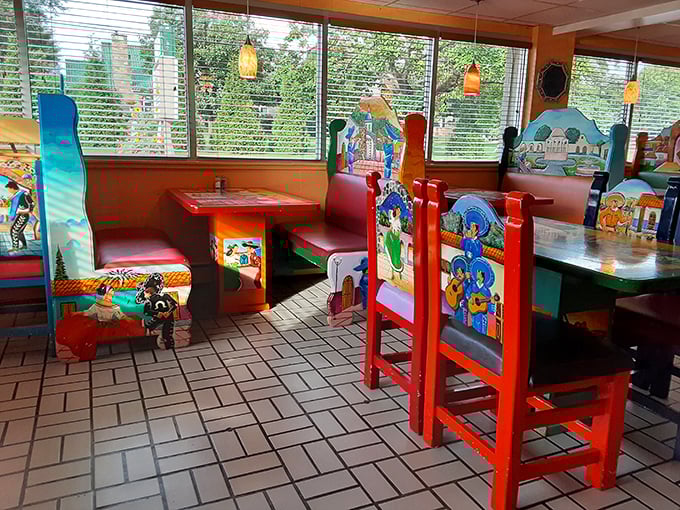 Natural light streams through windows, illuminating the restaurant's vibrant seating area—each chair a unique canvas celebrating Mexican culture and countryside.