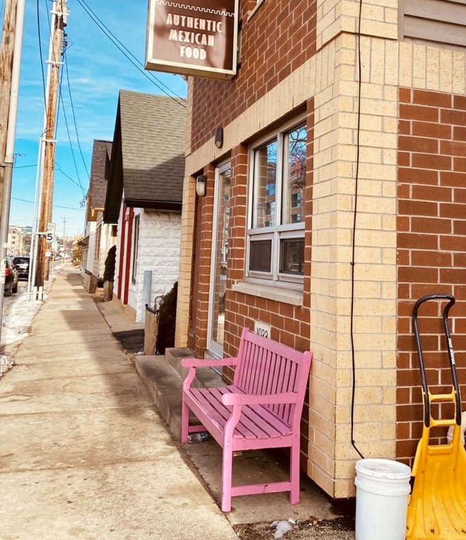 That pink bench isn't just seating – it's the most cheerful sentinel on South Park Street, standing guard outside flavor paradise.